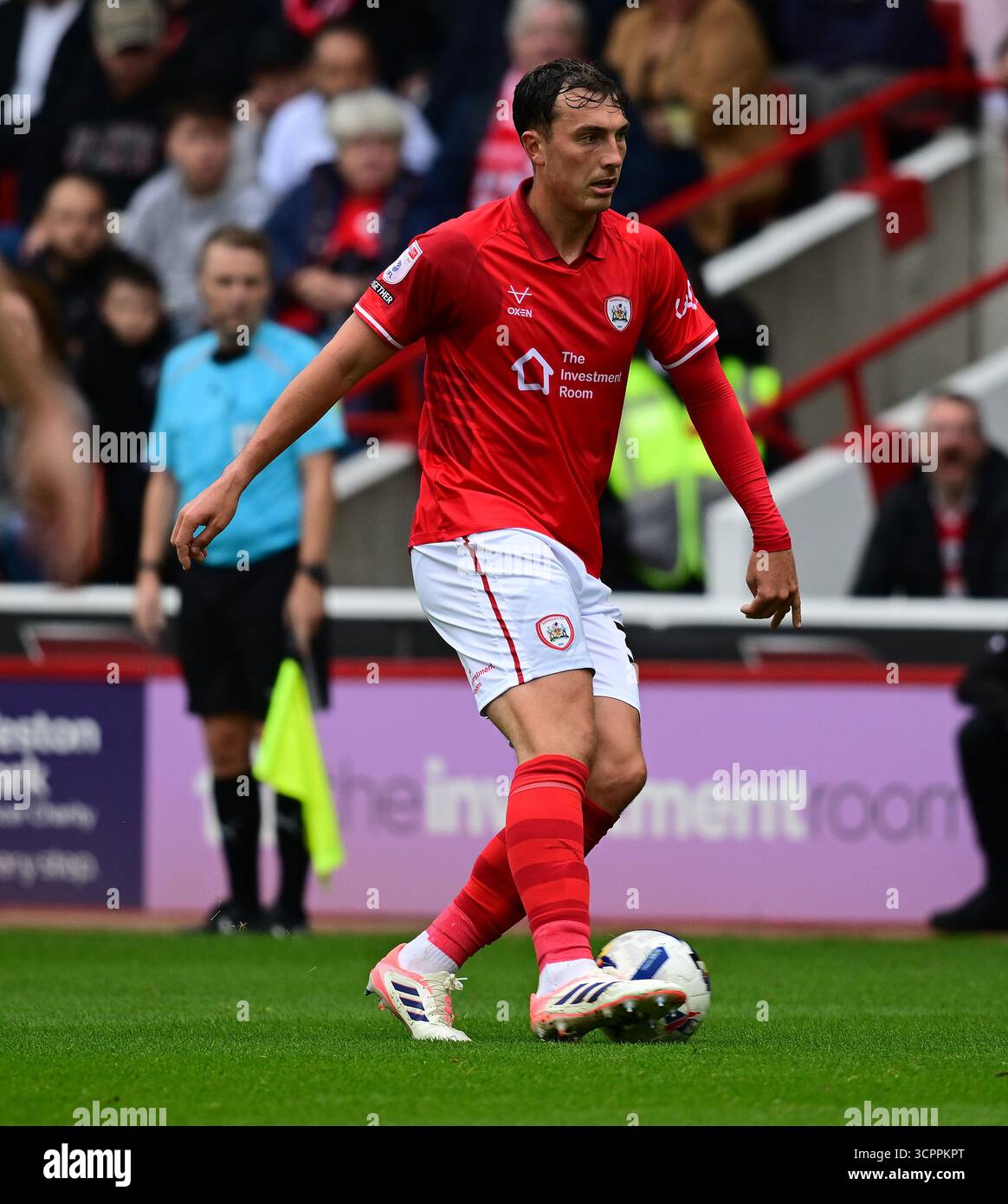 Barnsley's Josh Earl looks to play the ball forward in the match ...