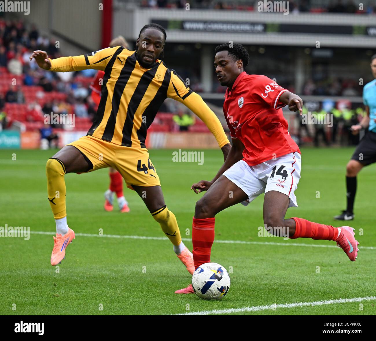 Barnsley's Nathanael Ogbeta battles for the ball against Port Vale's Devante Cole in the match ...