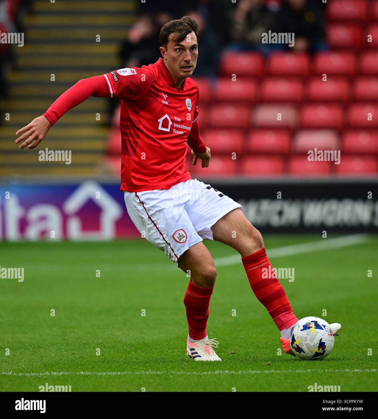 Barnsley's Josh Earl dribbles with the ball in the match between ...