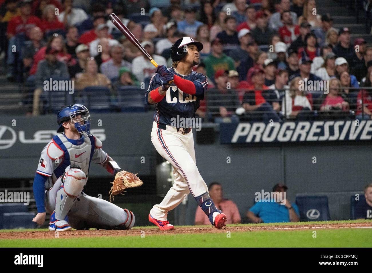 Cleveland Guardians' Jose Ramirez, right, watches his hit along with ...