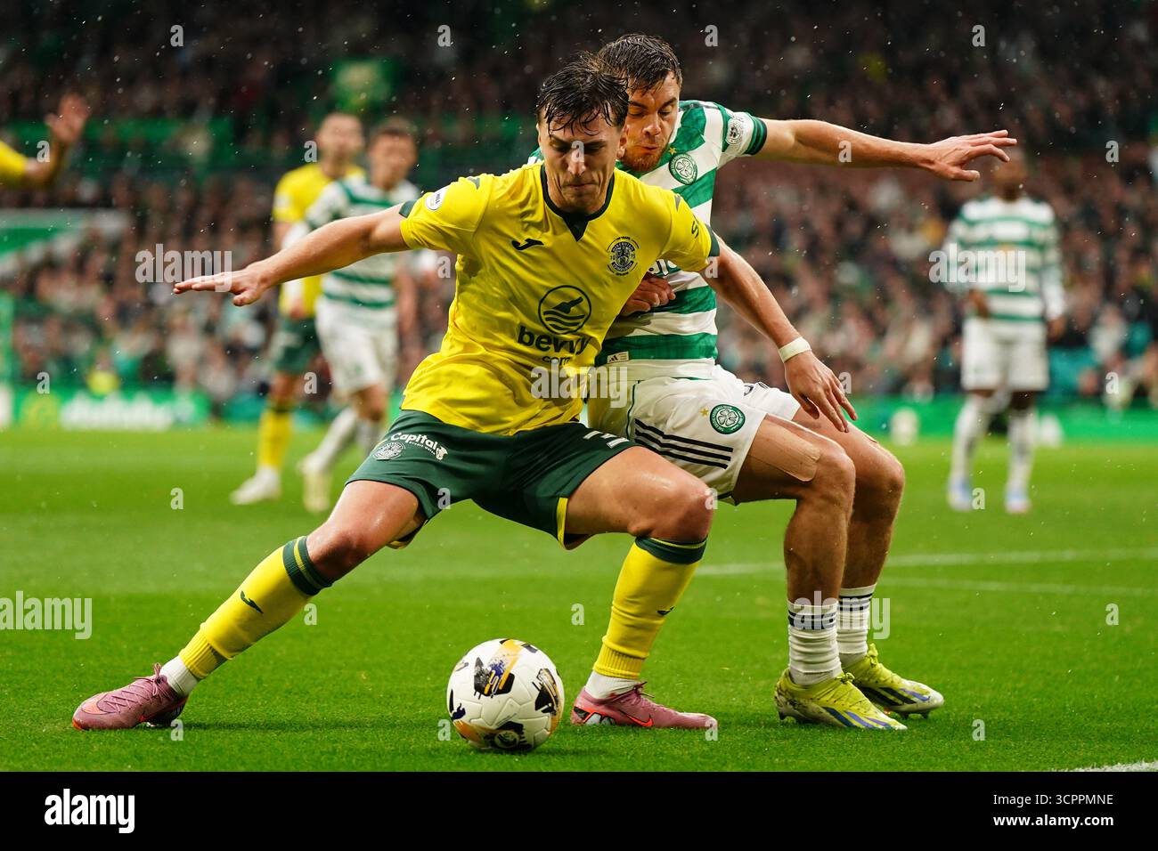 Hibernian's Josh Campbell (left) and Celtic’s James Forrest battle for ...