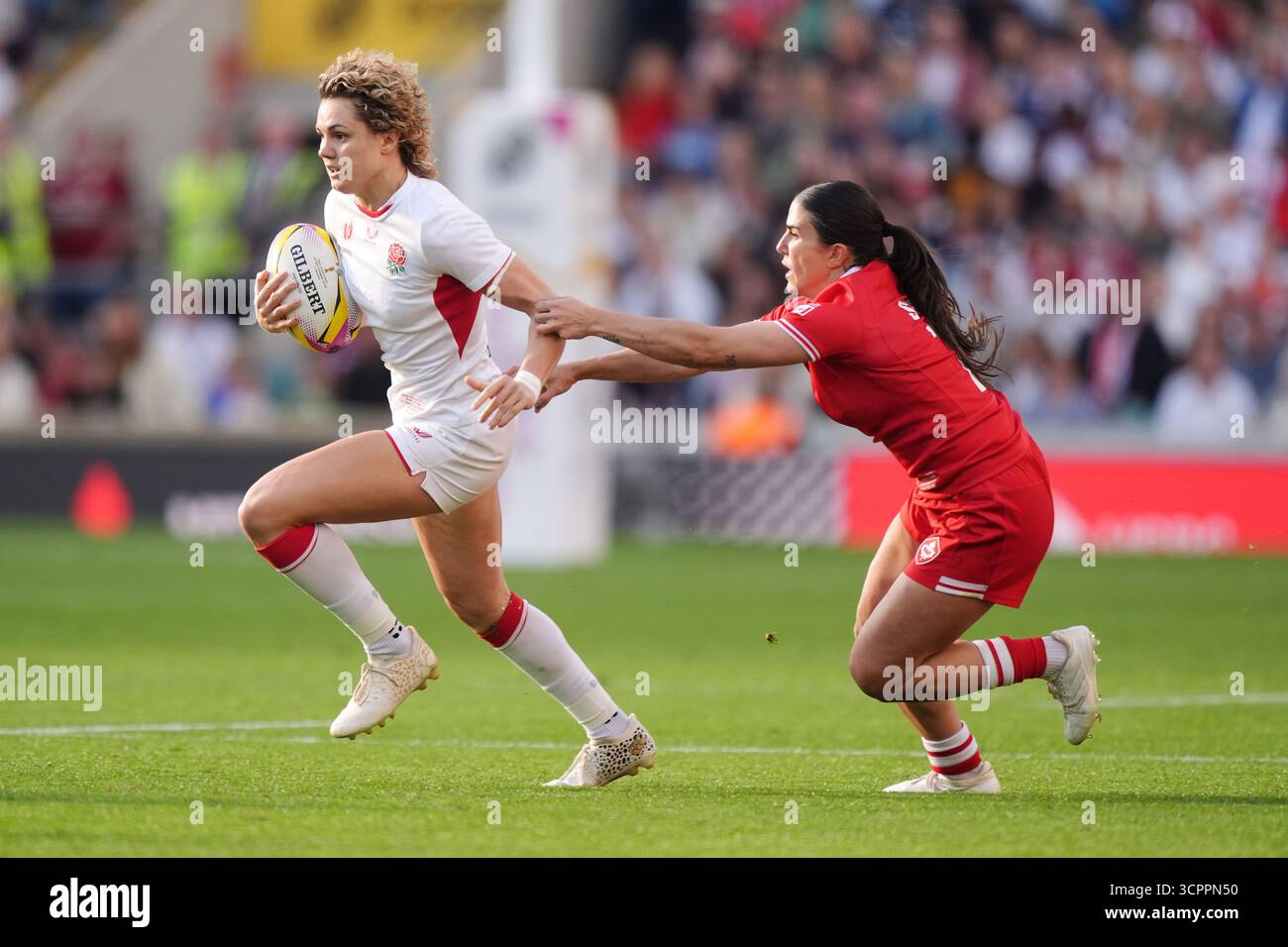 England's Ellie Kildunne (left) gets away from Canada's Julia Schell ...