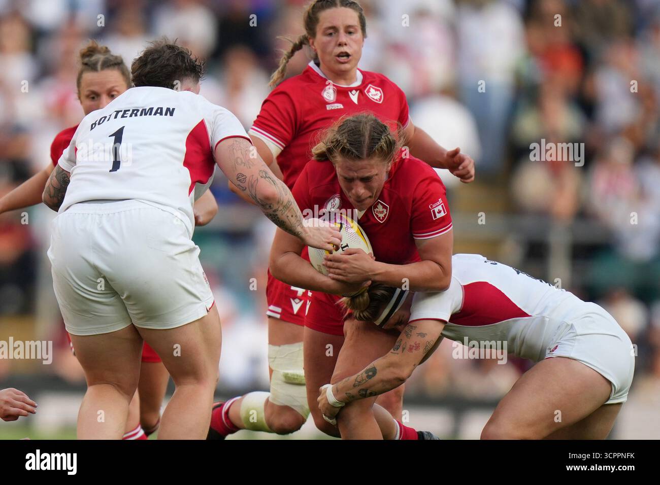 Canada's Emily Tuttosi, centre, challenges for the ball with England's ...