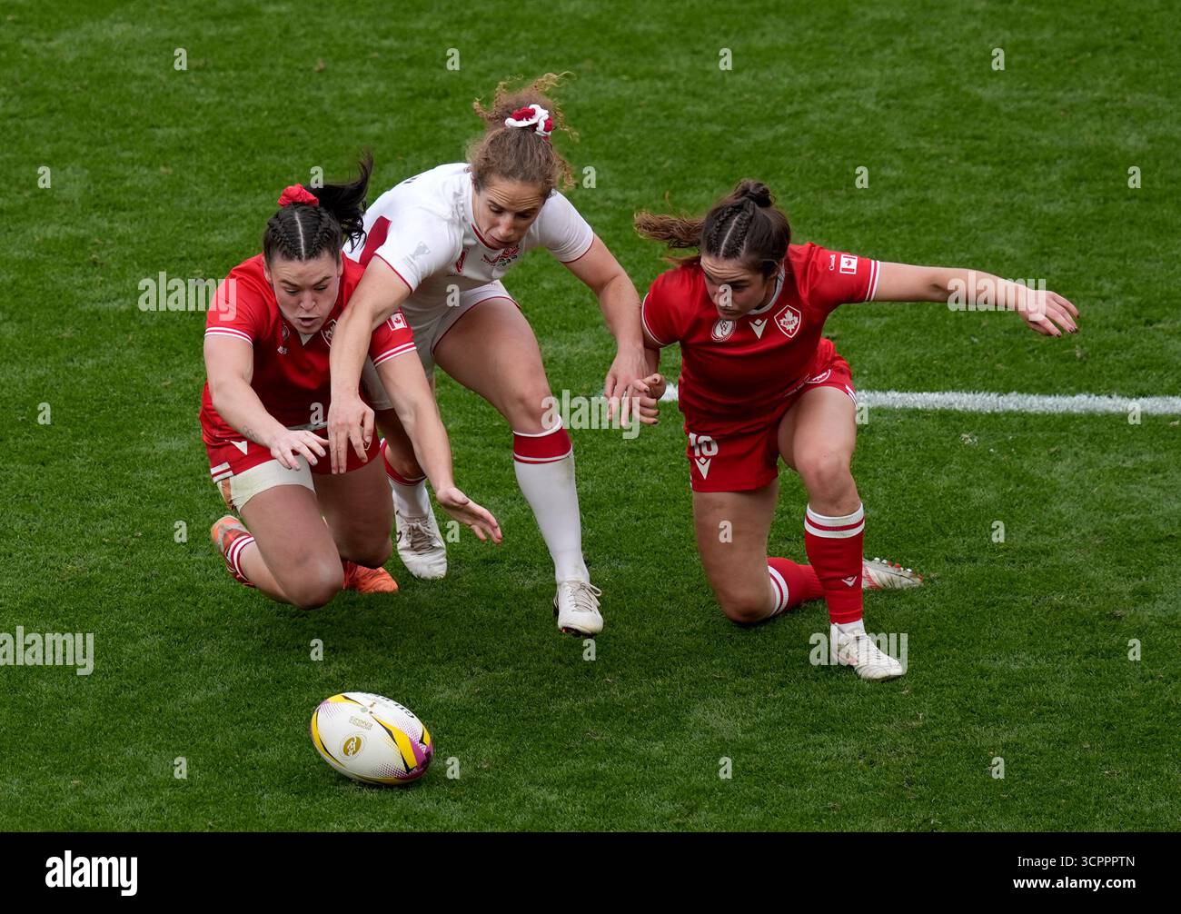 England's Abby Dow (centre) battles for a loses ball with Canada's Alysha Corrigan (left) and ...