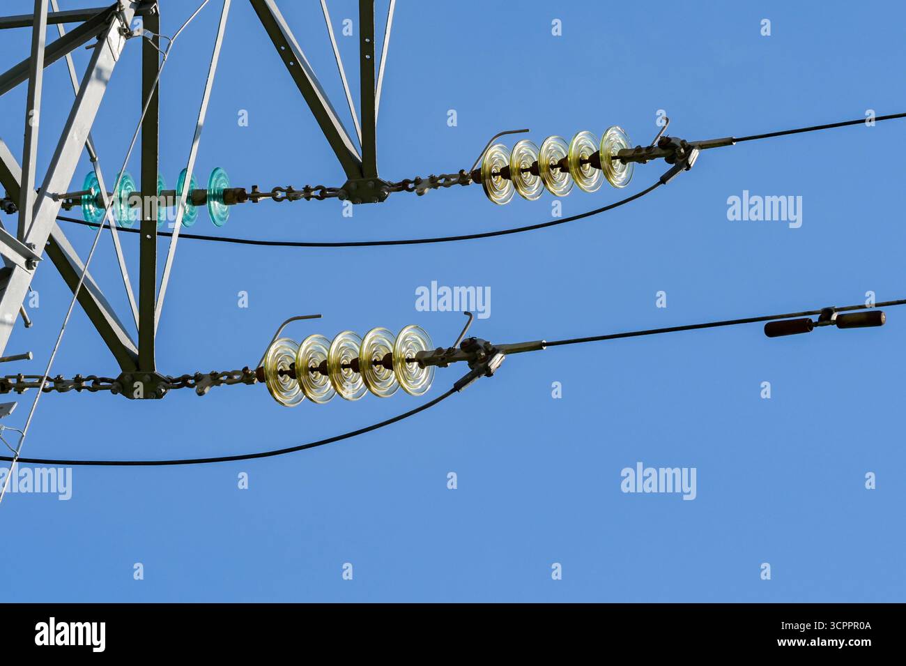 Close up view of the insulators on high voltage power lines on pylons ...