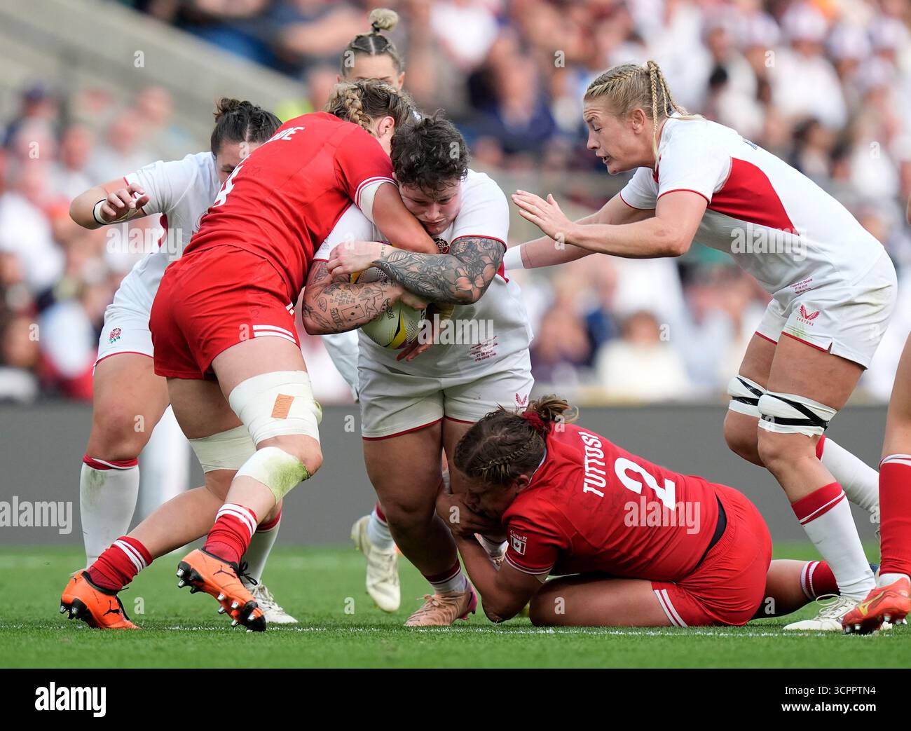 England's Hannah Botterman (centre) is tackled by Canada's Sophie de ...