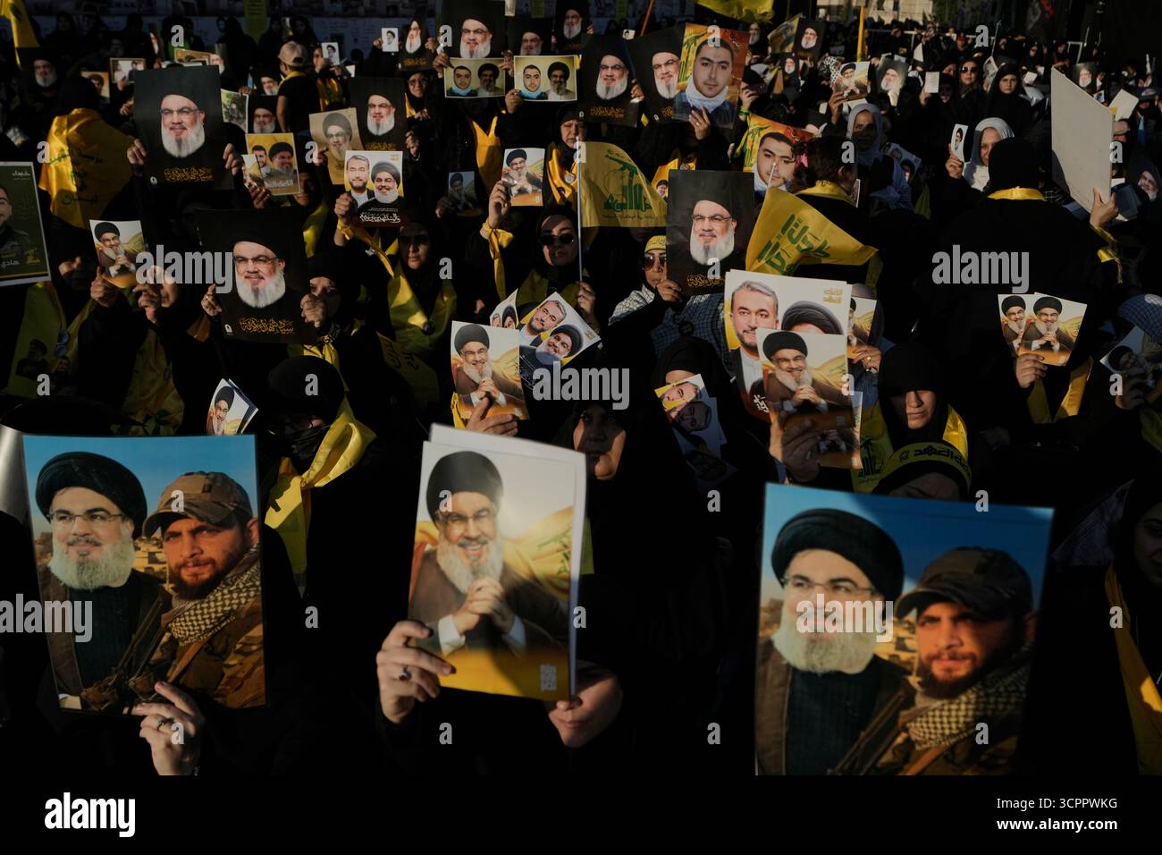 Hezbollah supporters hold pictures of Hezbollah leader Sayyed Hassan ...
