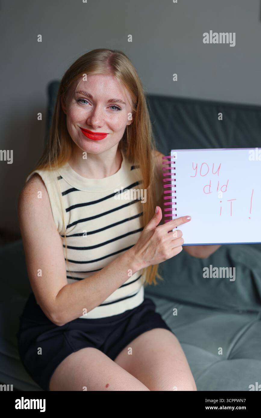 Cheerful woman with red lipstick holding positive note You did it ...
