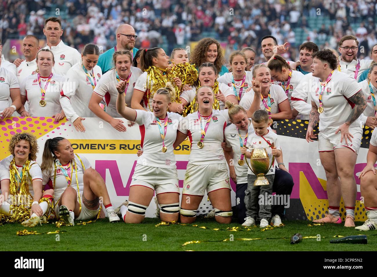 England's players celebrate with the Women's Rugby World trophy after ...