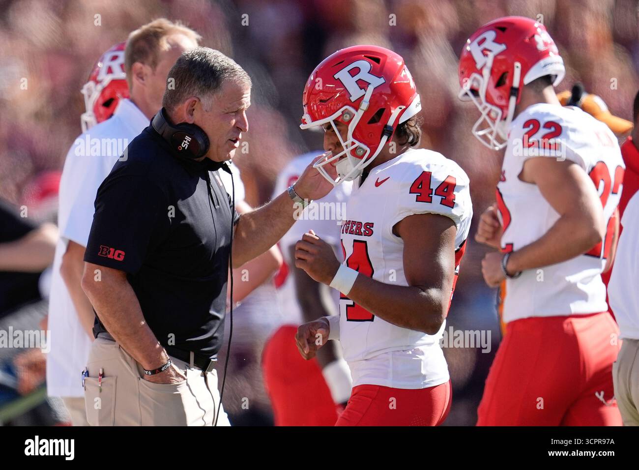 Rutgers head coach Greg Schiano, left, talks with place kicker Jai ...