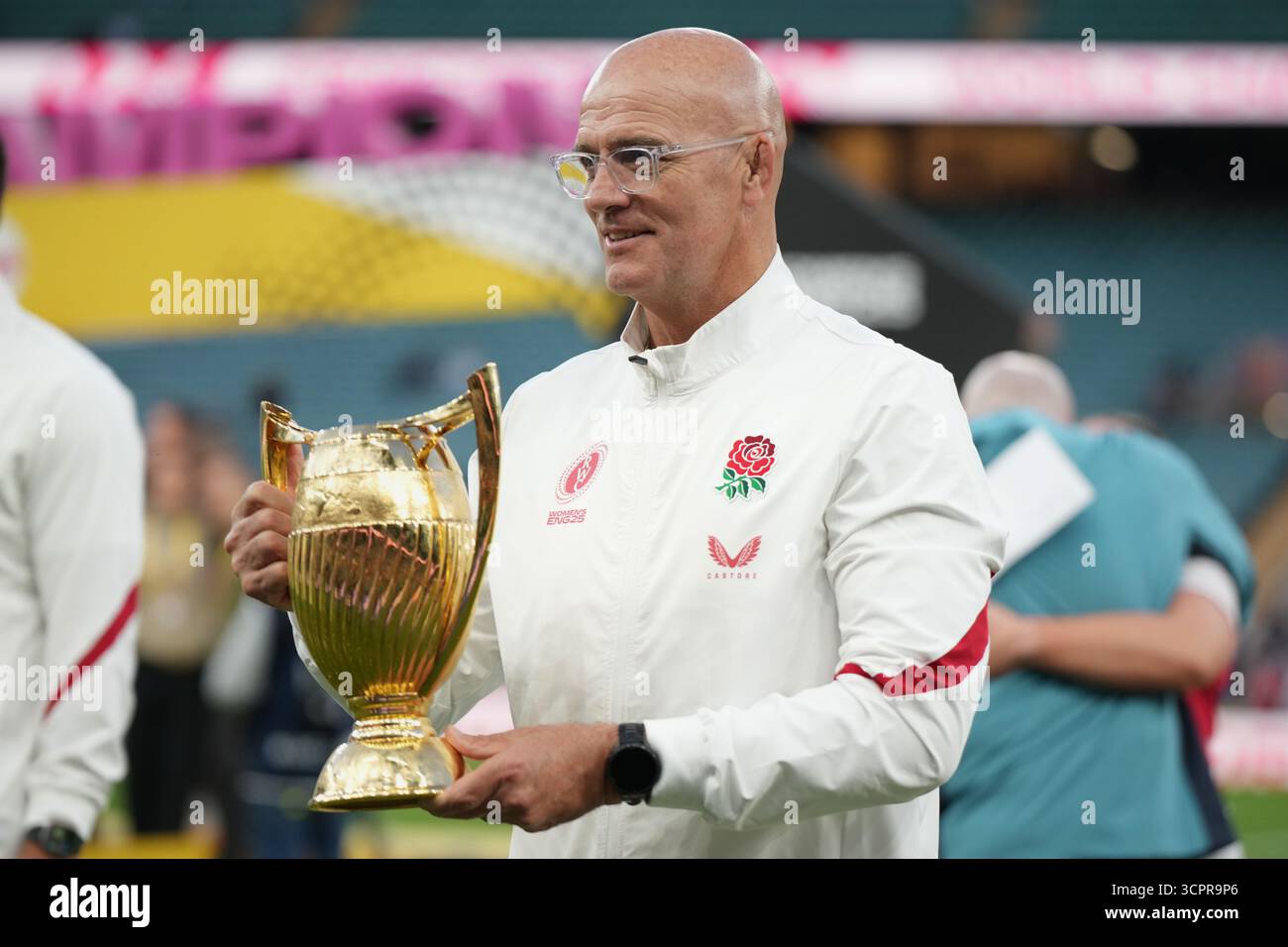 England's head coach John Mitchell holds a trophy after winning the ...