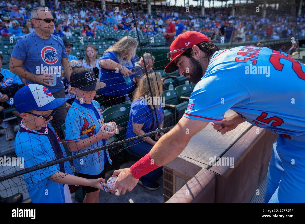 St. Louis Cardinals' Thomas Saggese (25) signs autographs for young ...