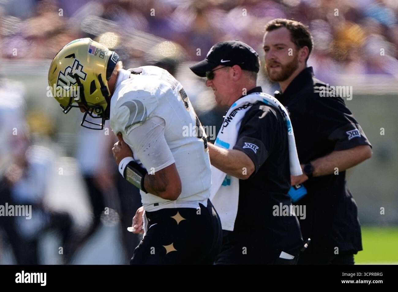 Central Florida quarterback Tayven Jackson is helped off the field ...