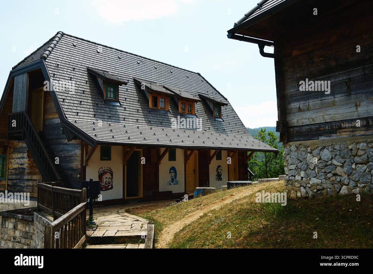 Traditional Balkan building in Drvengrad village with murals of famous ...
