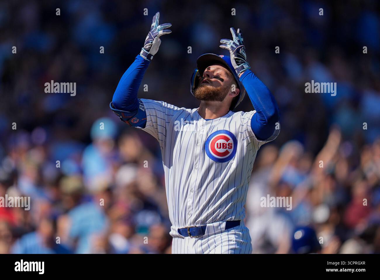 Chicago Cubs' Michael Busch (29) gestures skyward as he crosses home ...