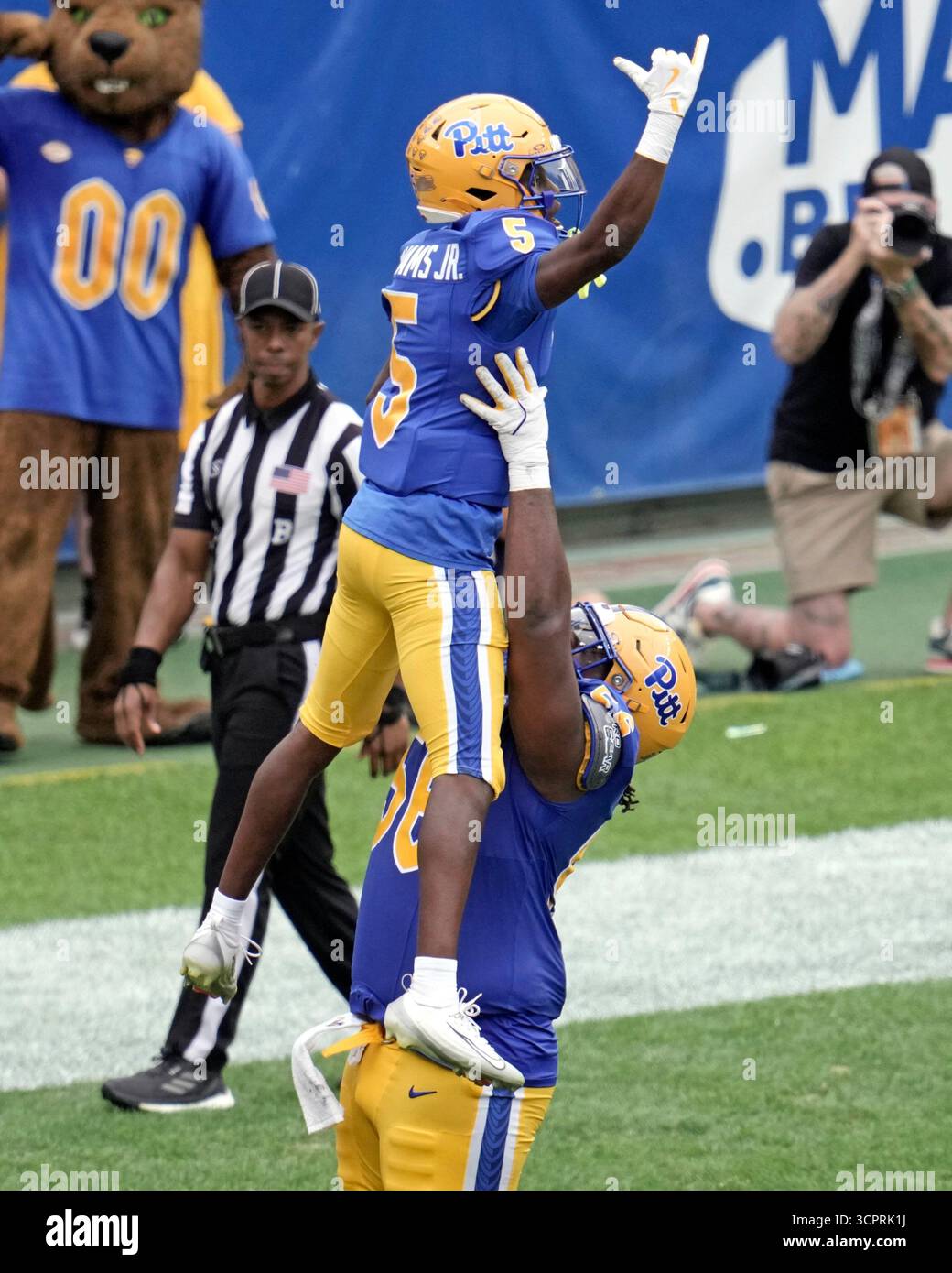 Pittsburgh wide receiver Raphael Williams Jr. (5) is lifted up by ...