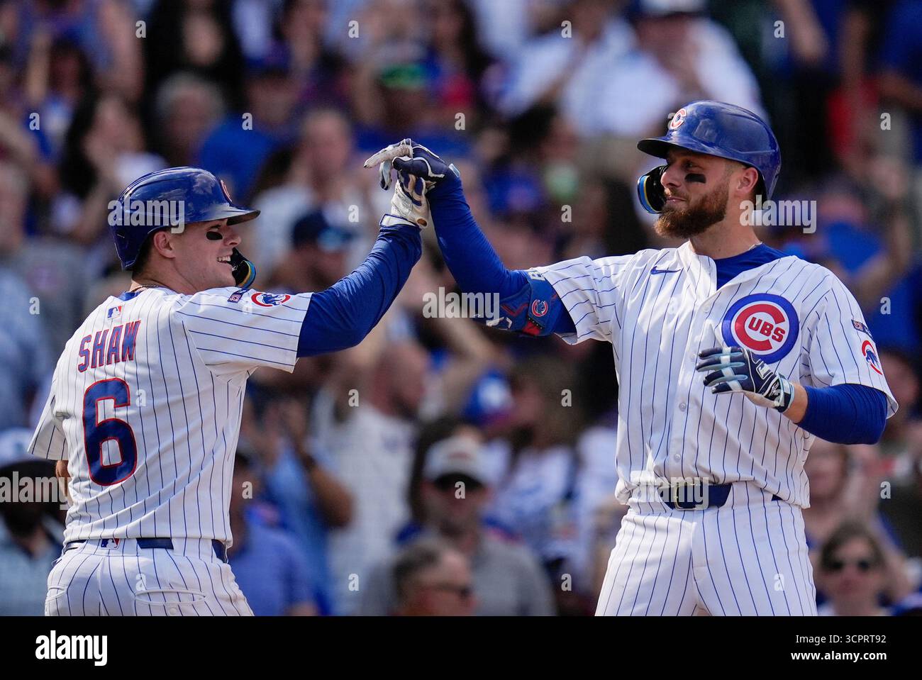 Chicago Cubs' Michael Busch, right, high-fives Matt Shaw (6) after ...