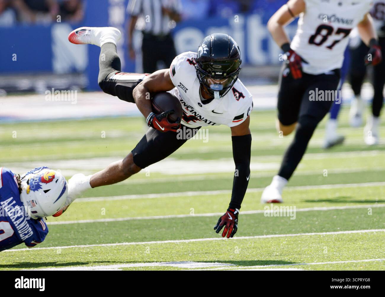 Cincinnati wide receiver Cyrus Allen (4) gets tripped up by Kansas ...
