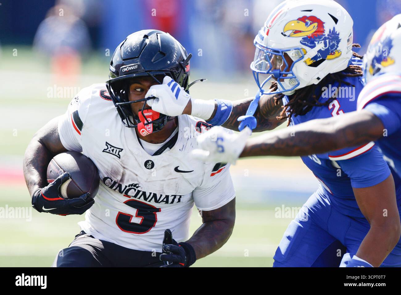Cincinnati running back Tawee Walker (3) is grabbed by the facemask by ...