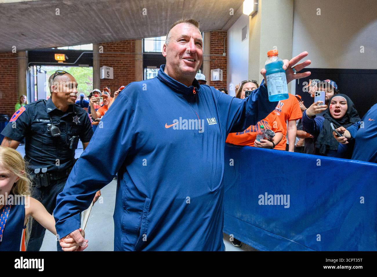 Illinois head coach Bret Bielema celebrates with fans following an NCAA ...