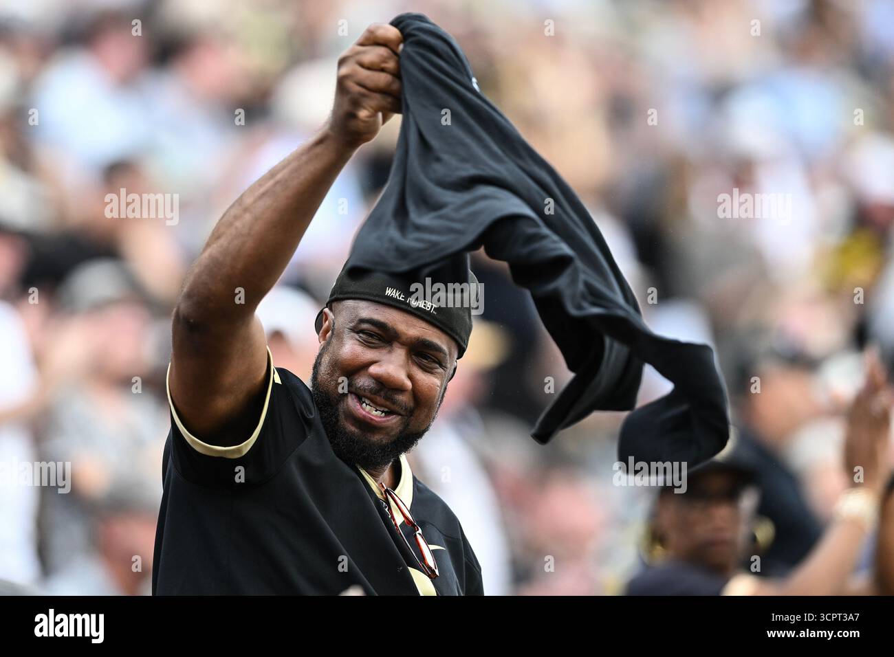 A fan cheers during the second half of an NCAA college football game between Georgia Tech and ...