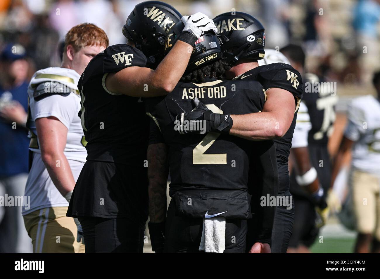 Wake Forest quarterback Robby Ashford (2) is consoled by teammates ...