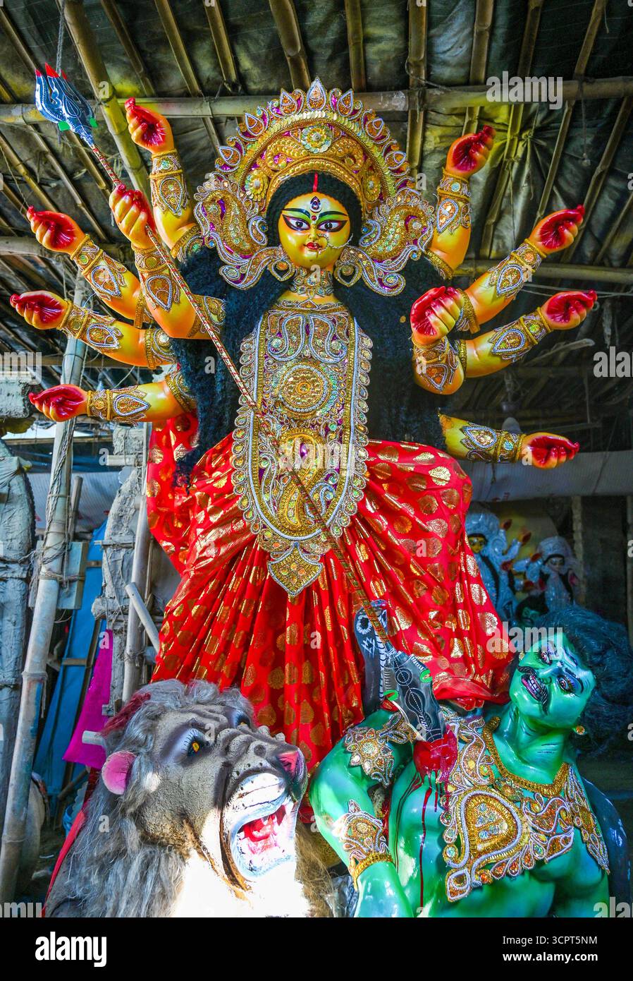NOIDA, INDIA - SEPTEMBER 25: An artist give finishing touches to an idol of Hindu goddess Durga ...