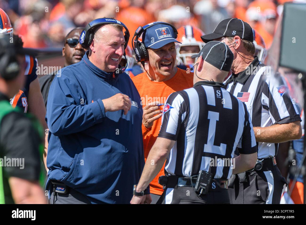 Illinois head coach Bret Bielema shares a laugh with officials during ...