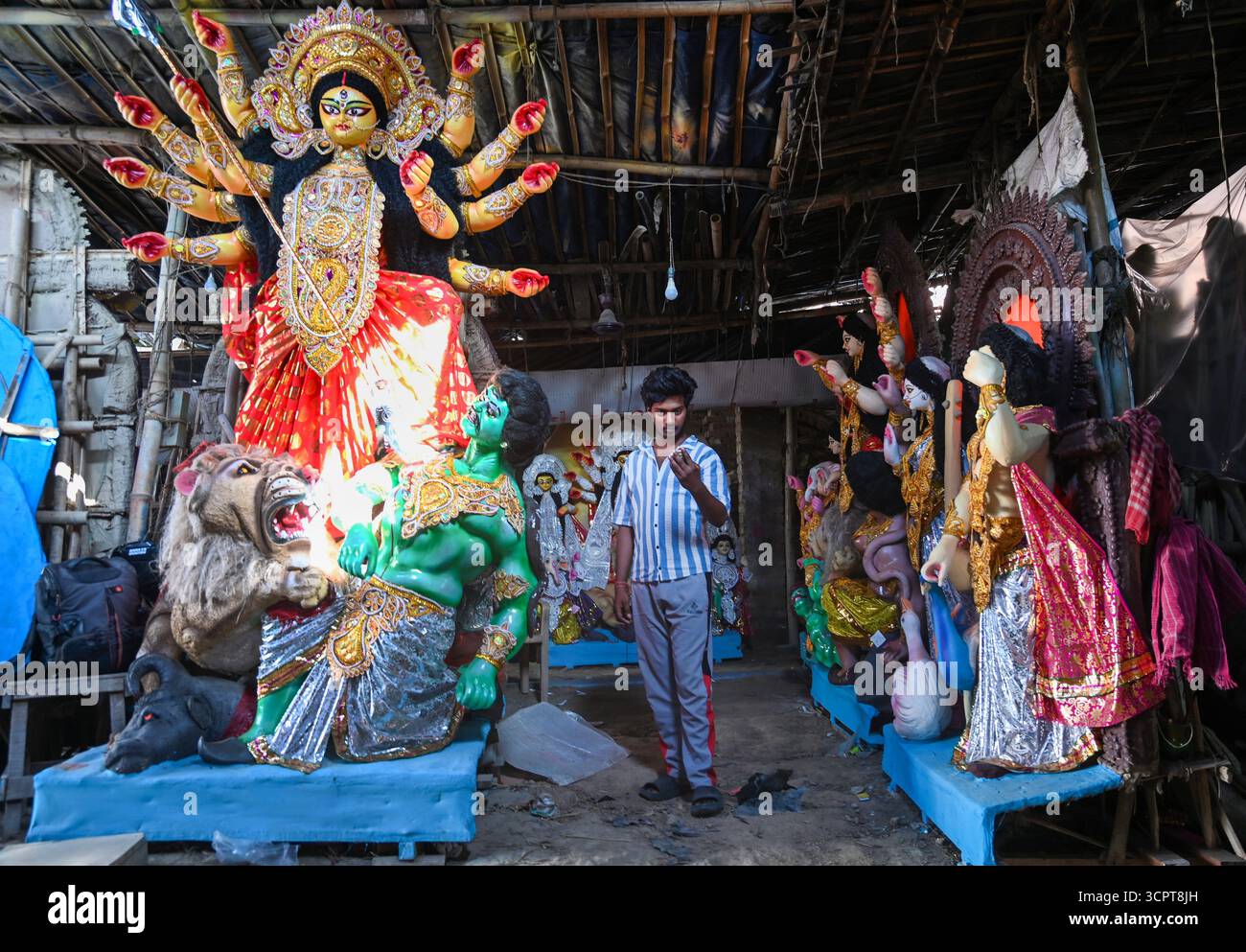 NOIDA, INDIA - SEPTEMBER 25: An artist give finishing touches to an idol of Hindu goddess Durga ...