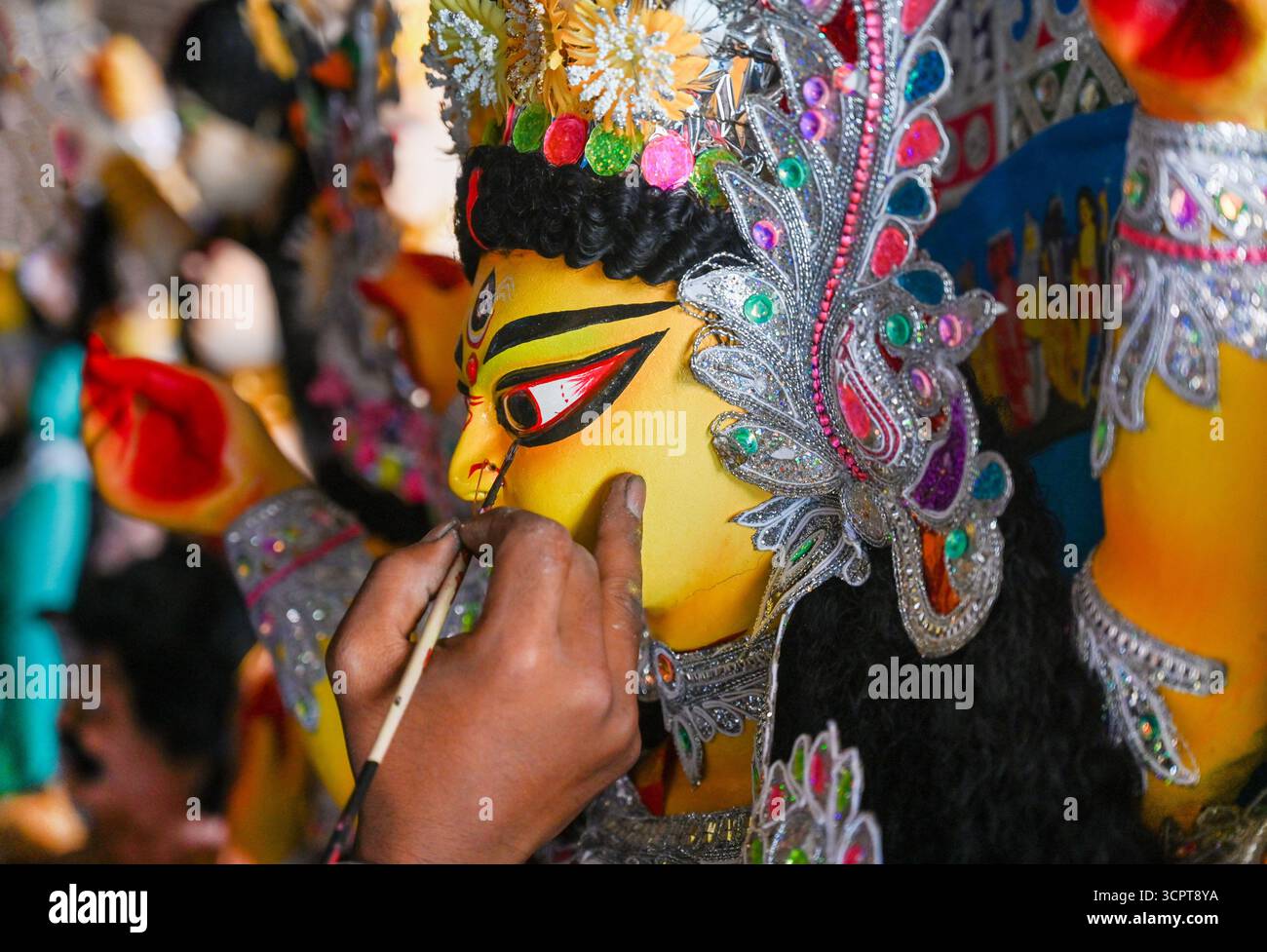 NOIDA, INDIA - SEPTEMBER 25: An artist give finishing touches to an idol of Hindu goddess Durga ...