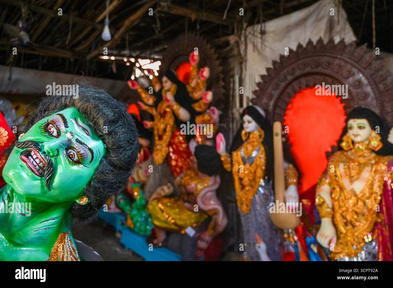 NOIDA, INDIA - SEPTEMBER 25: An artist give finishing touches to an idol of Hindu goddess Durga ...