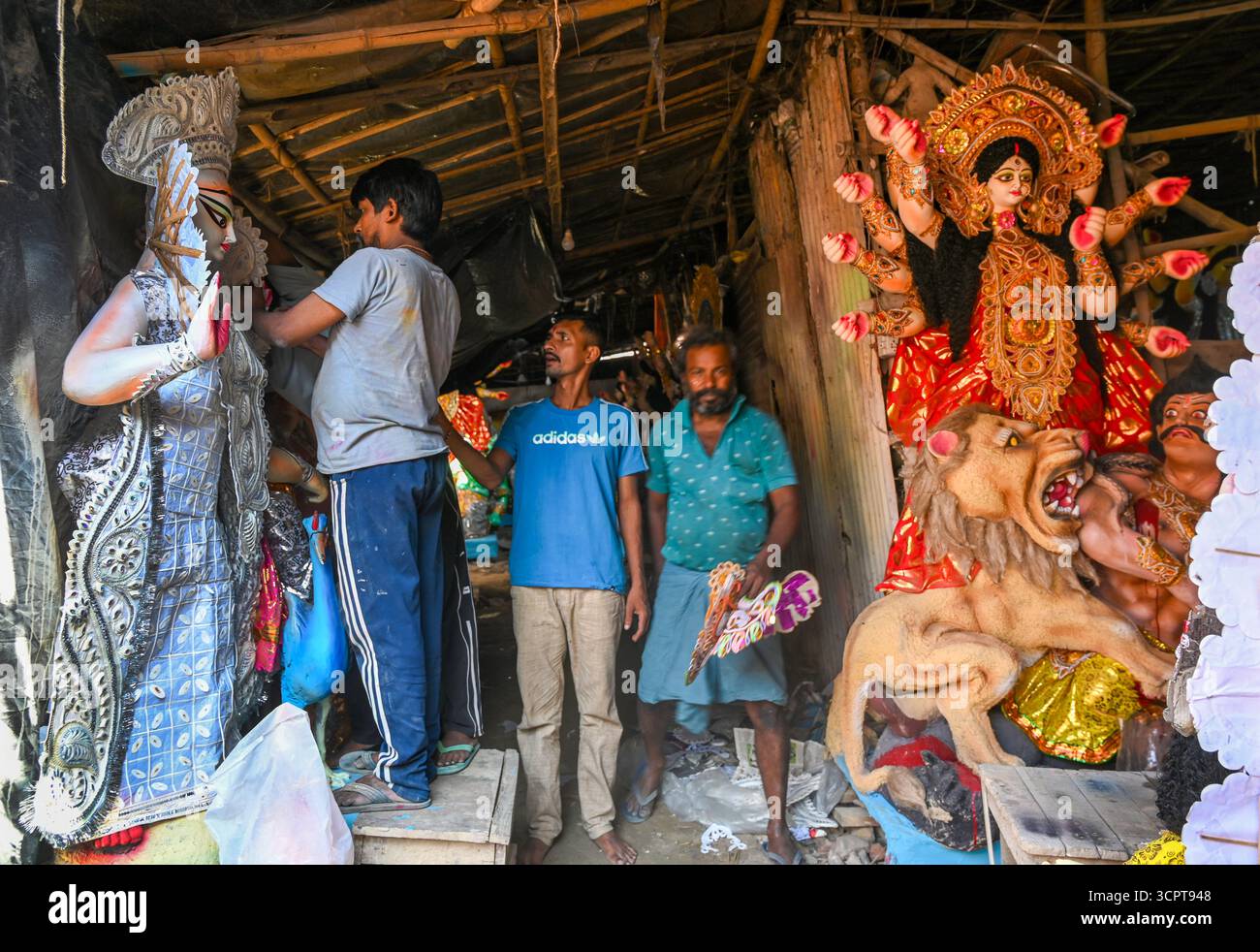NOIDA, INDIA - SEPTEMBER 25: An artist give finishing touches to an idol of Hindu goddess Durga ...