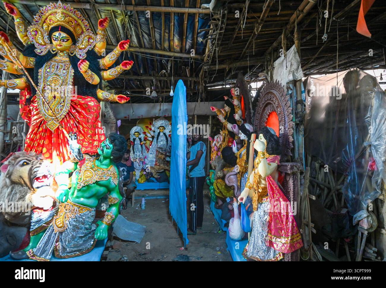 NOIDA, INDIA - SEPTEMBER 25: An artist give finishing touches to an idol of Hindu goddess Durga ...