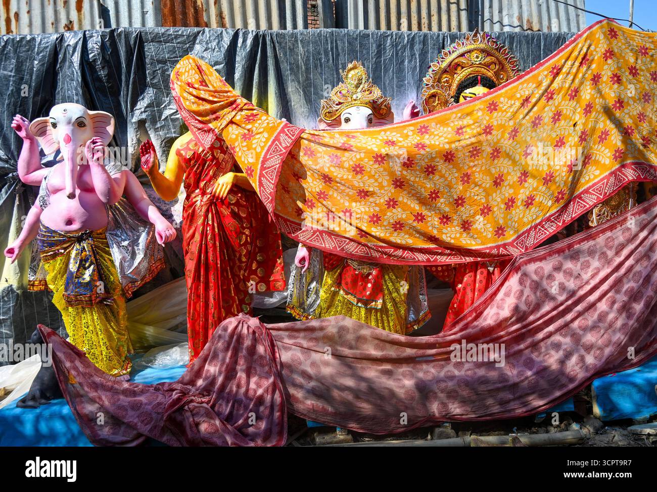 NOIDA, INDIA - SEPTEMBER 25: An artist give finishing touches to an idol of Hindu goddess Durga ...