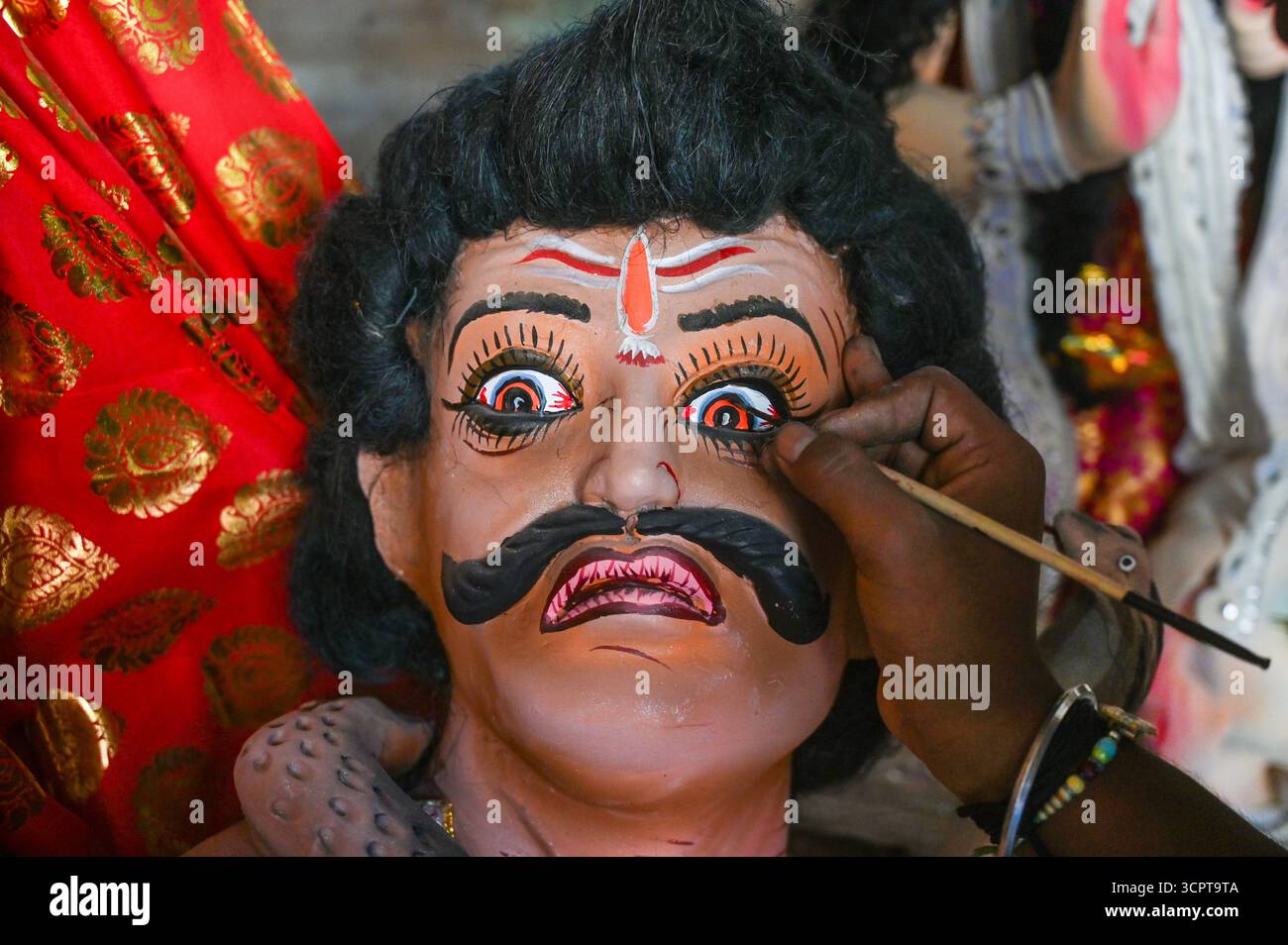 NOIDA, INDIA - SEPTEMBER 25: An artist give finishing touches to an idol of Hindu goddess Durga ...