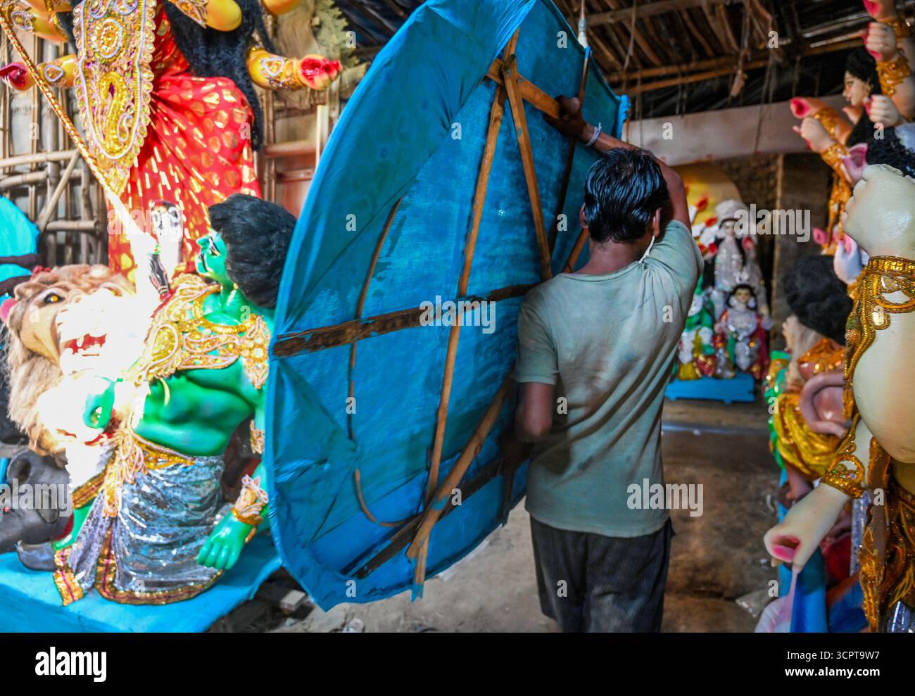 NOIDA, INDIA - SEPTEMBER 25: An artist give finishing touches to an idol of Hindu goddess Durga ...