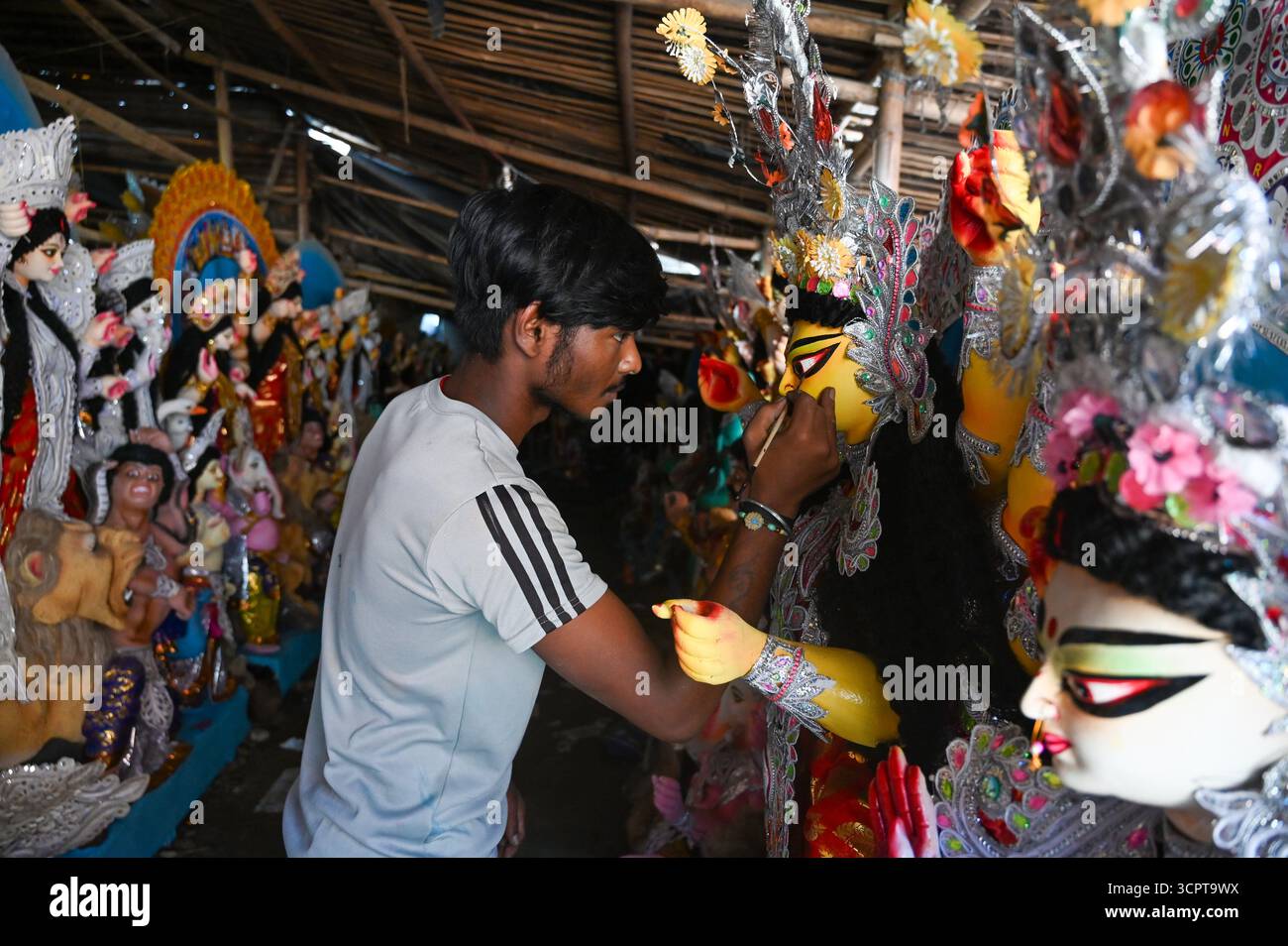 NOIDA, INDIA - SEPTEMBER 25: An artist give finishing touches to an idol of Hindu goddess Durga ...