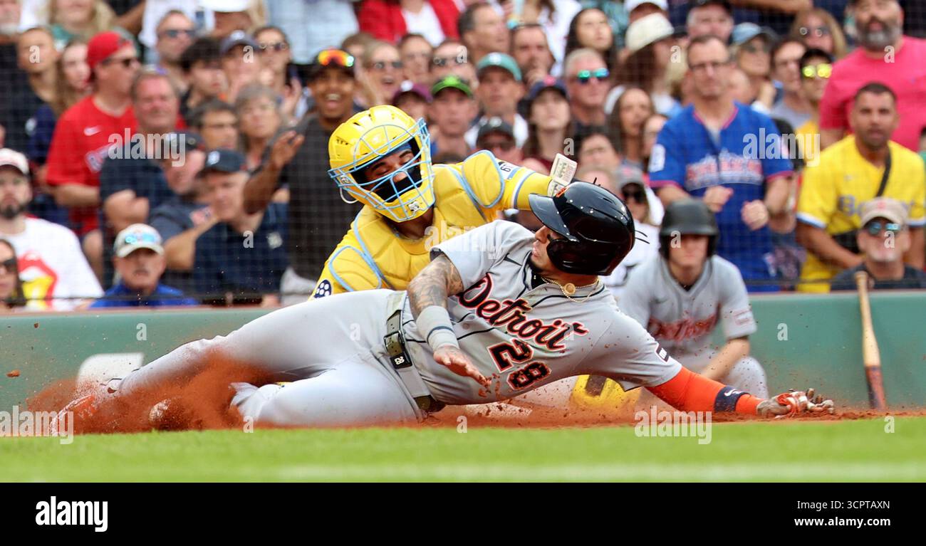 Detroit Tigers' Javier Báez (28) slides safely into home plate as Boston Red Sox catcher Carlos ...