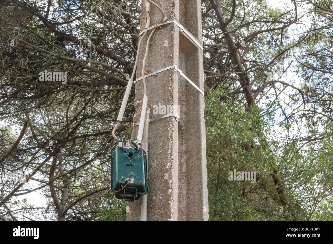 Close up of an electrical junction box attached to a concrete utility ...