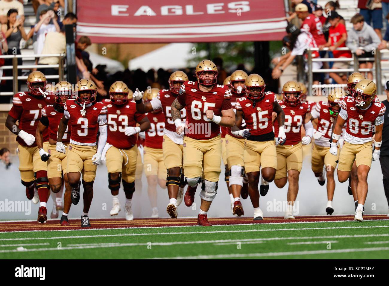 Boston College offensive lineman Logan Taylor (65) leads the team onto ...