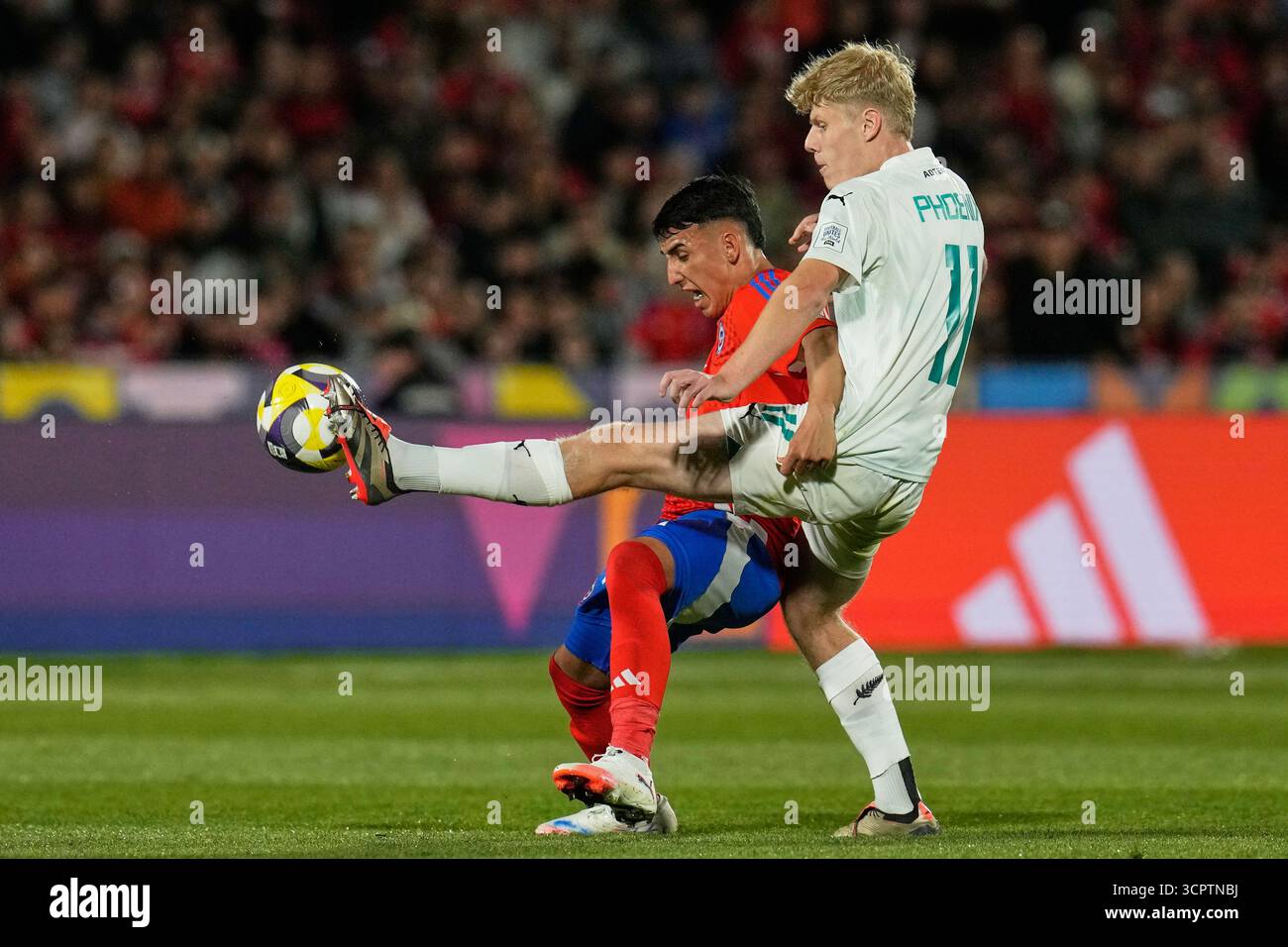 New Zealand's Codey Phoenix, front, and Chile's Lautaro Millan battle for the ball during a FIFA ...