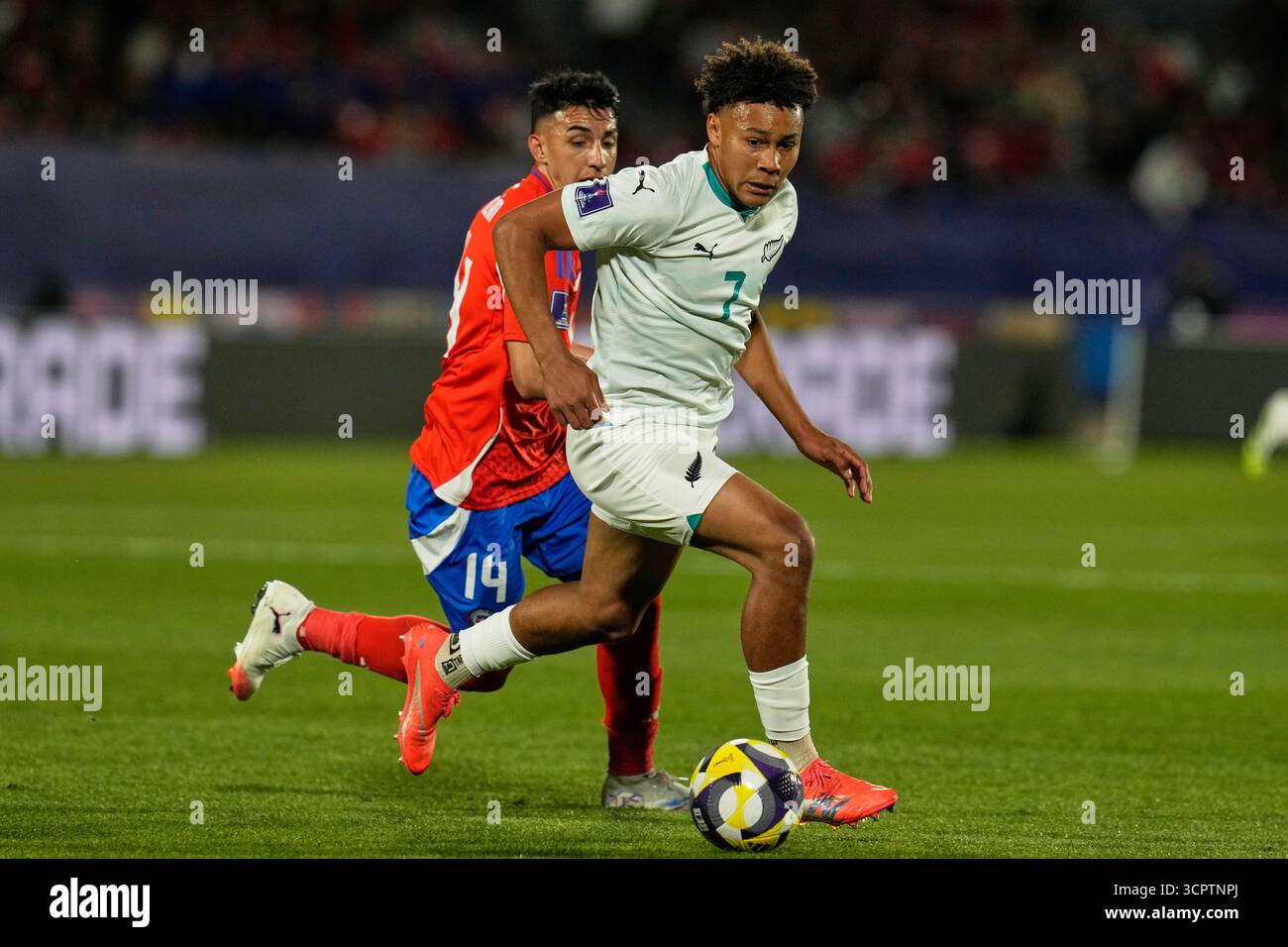 New Zealand's Luke Brooke-Smith, front, controls a ball chased by Chile ...