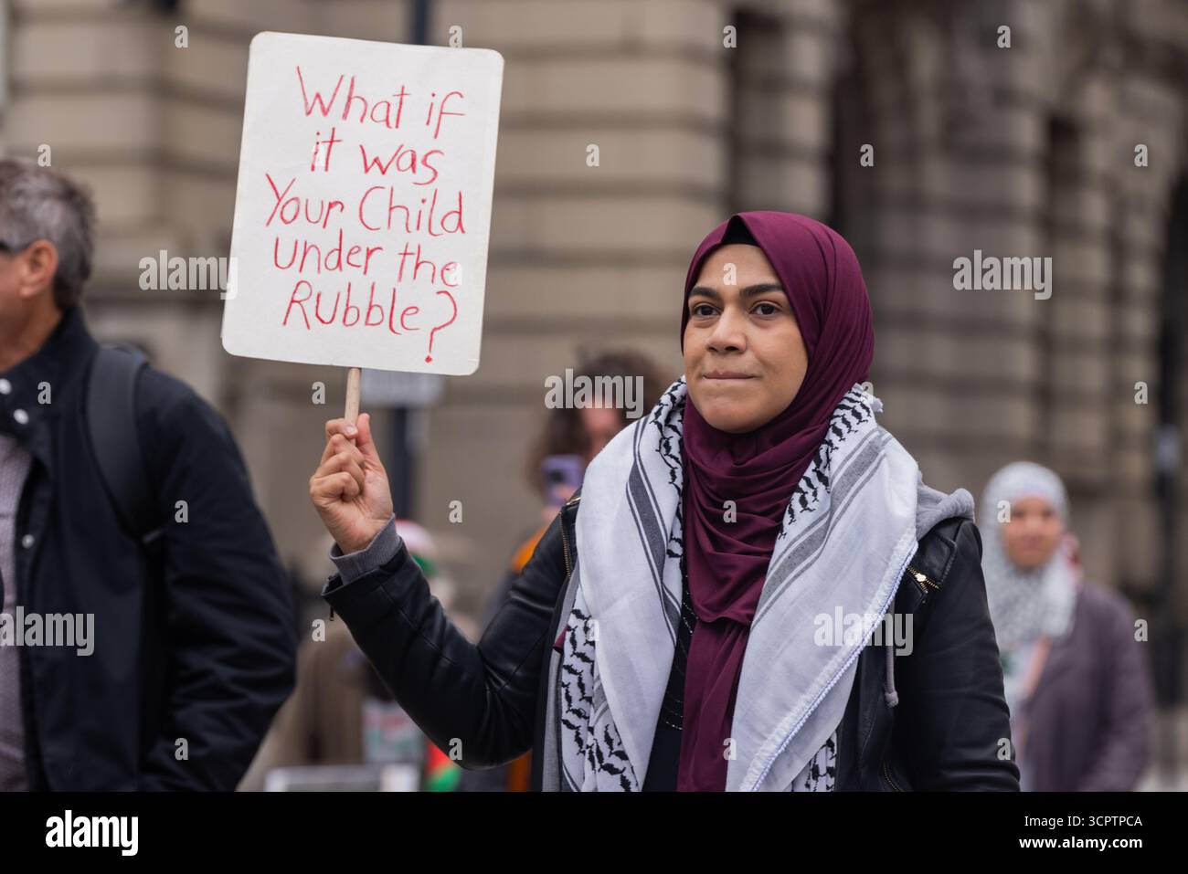 Liverpool, UK. 27 SEP, 2025. Lady holds "What if it was your child ...
