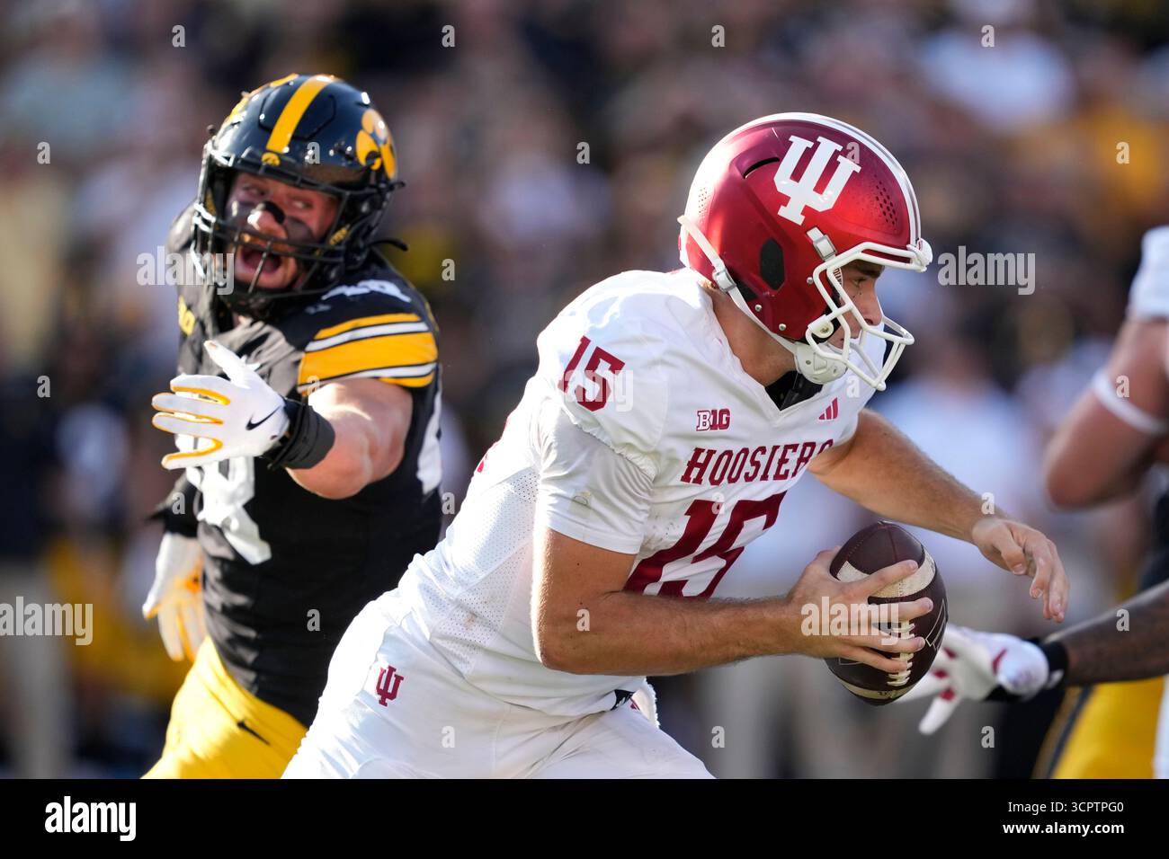 Indiana quarterback Fernando Mendoza (15) runs from Iowa defensive ...