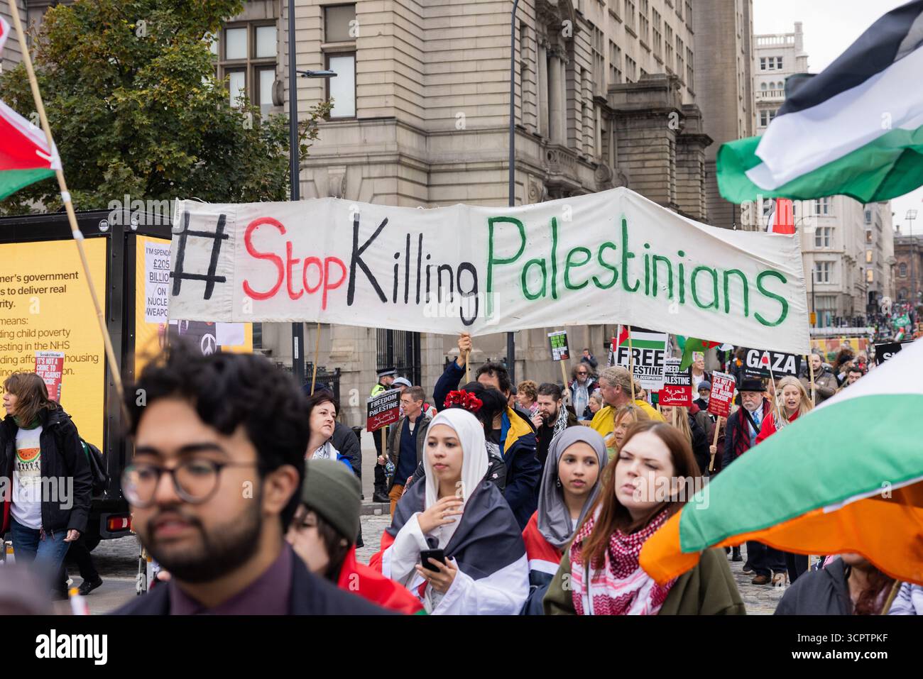 Liverpool, UK. 27 SEP, 2025. People carry "StopKillingPalestinians ...