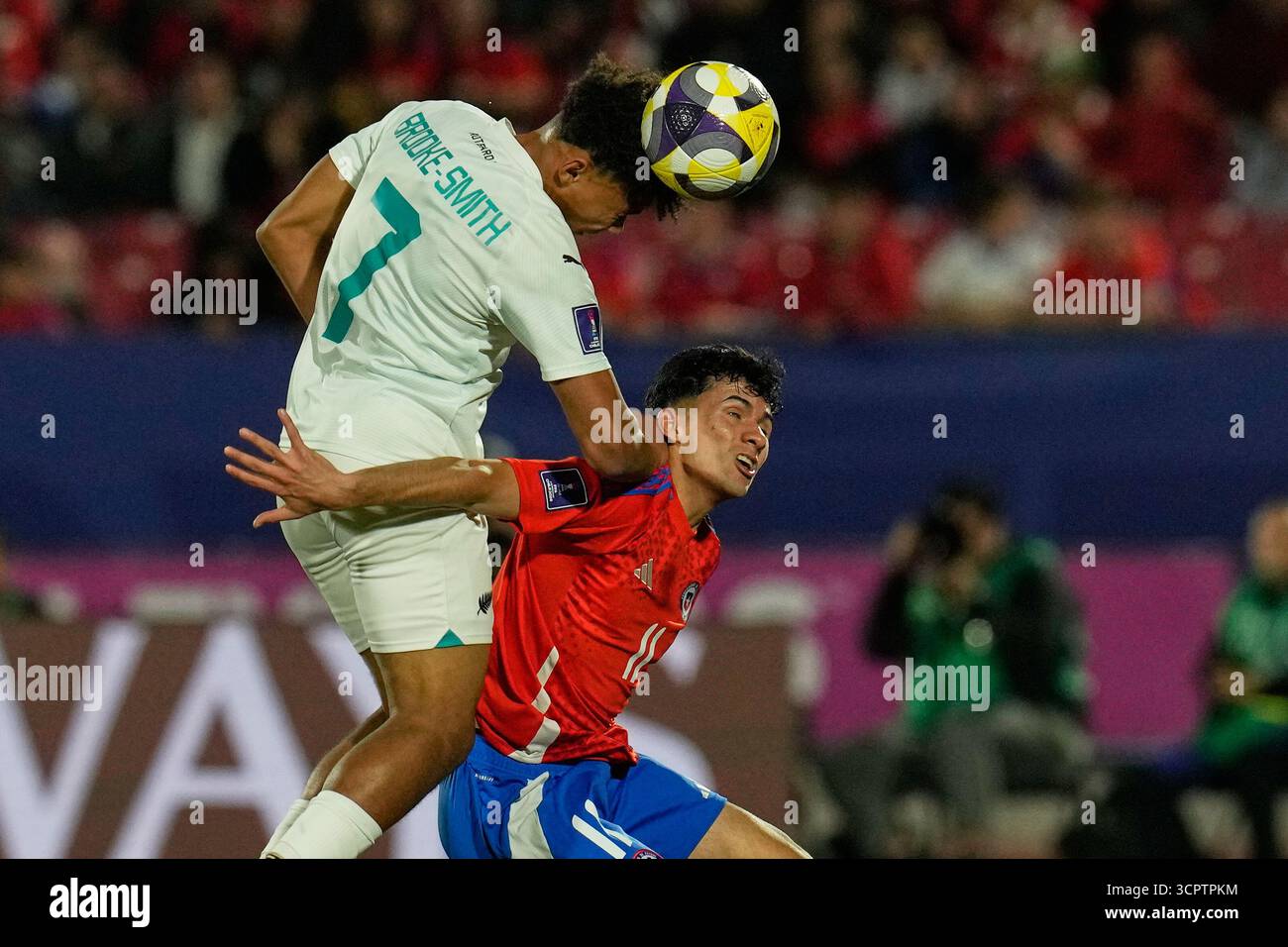 New Zealand's Luke Brooke-Smith, top, heads the ball next to Chile's ...