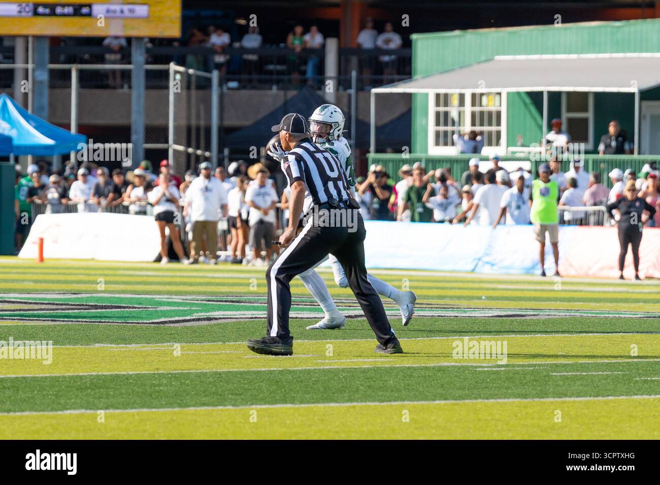 Landon Sims of UH snags a pass at midfield and powers forward ...