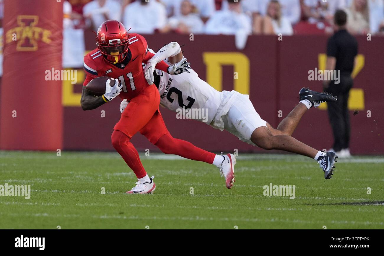 Arizona wide receiver Chris Hunter (11) runs the ball as he is tackled ...