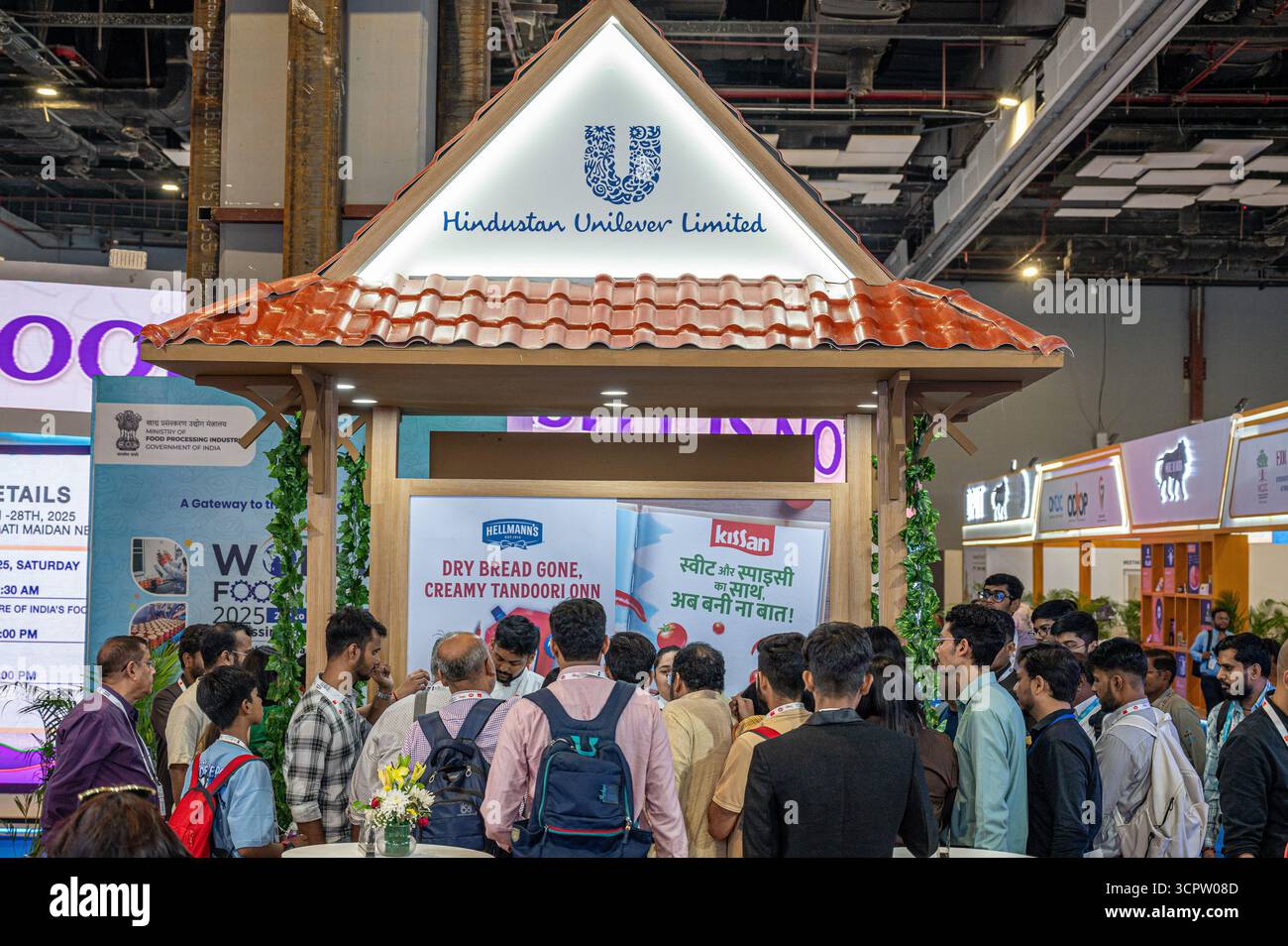Visitors gather to taste food in front of the live cooking demo area at ...
