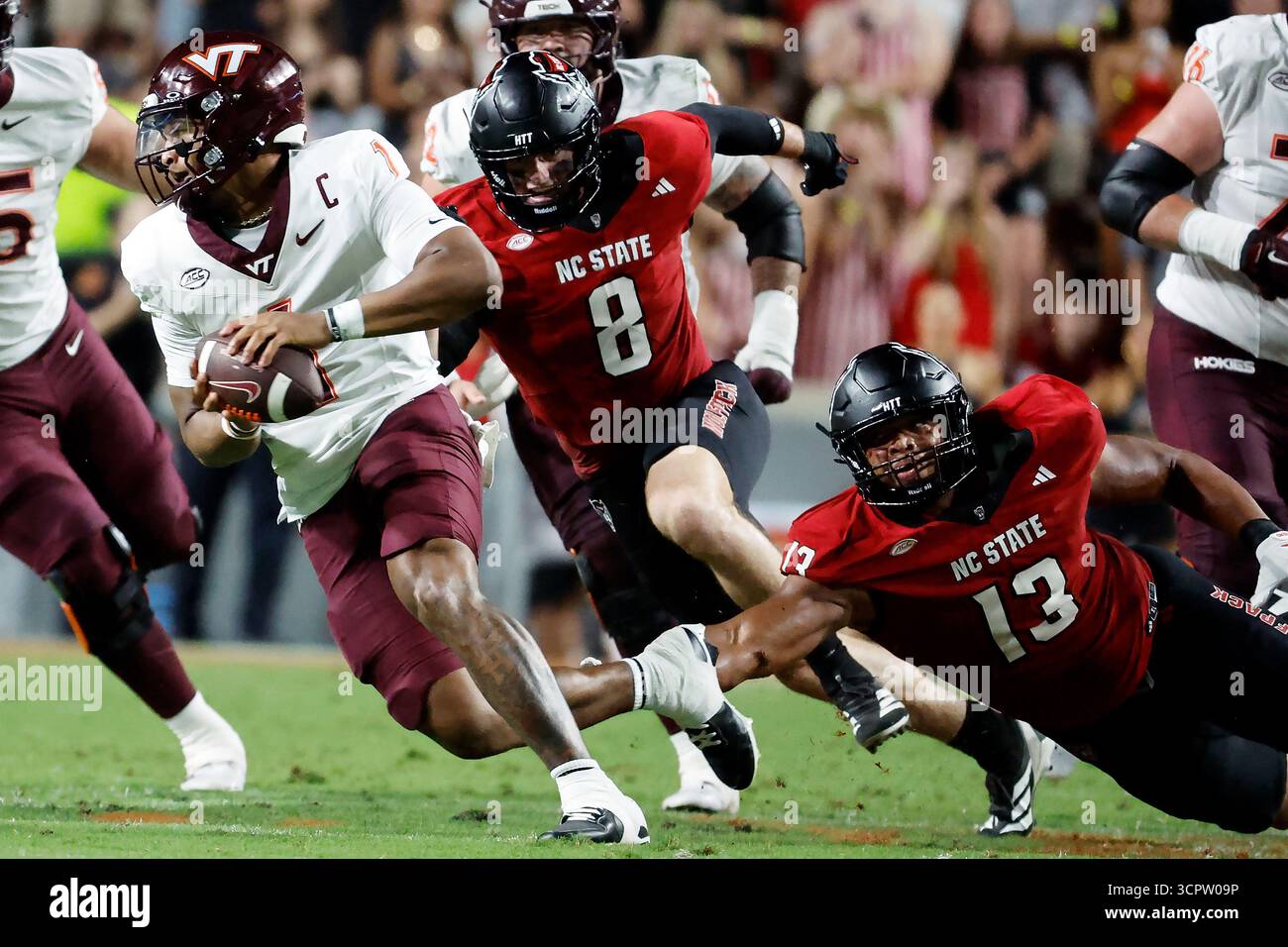 Virginia Tech quarterback Kyron Drones (1) avoids the rush of North ...